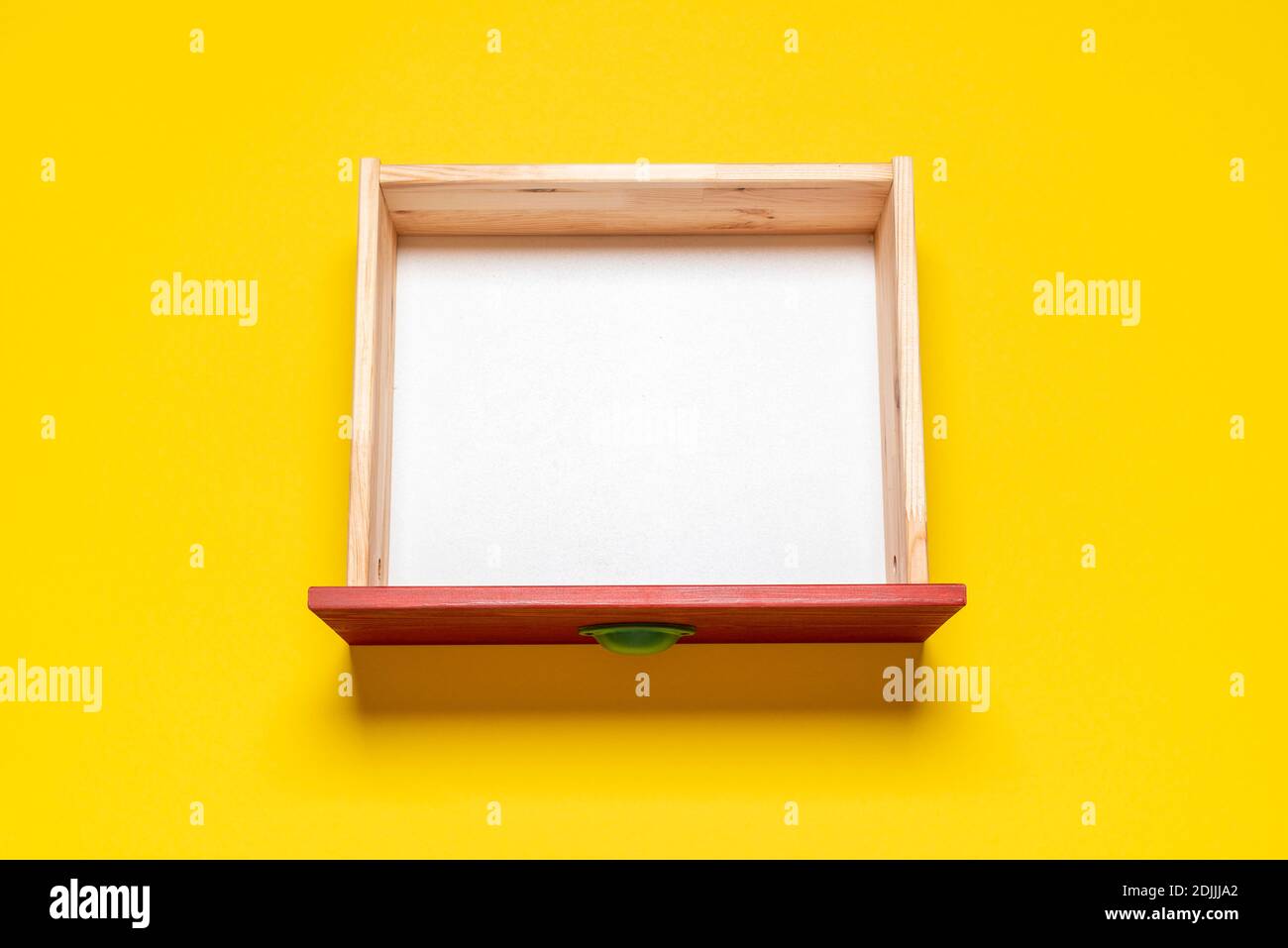 Top view with an empty drawer isolated on a yellow background. Wooden ...