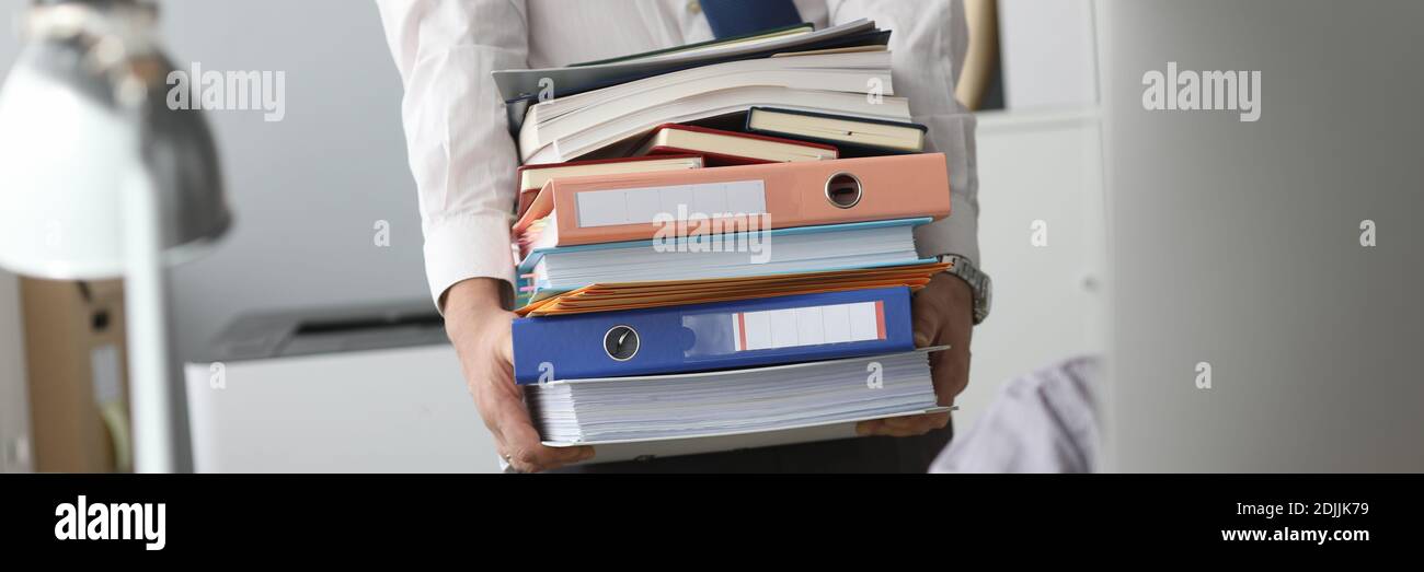 Office worker holding papers, folders, notebooks and documents Stock ...