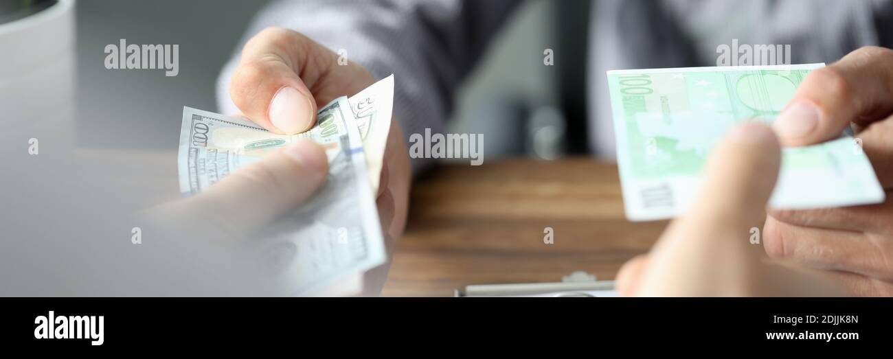 Two men exchanging money with each other in office Stock Photo - Alamy