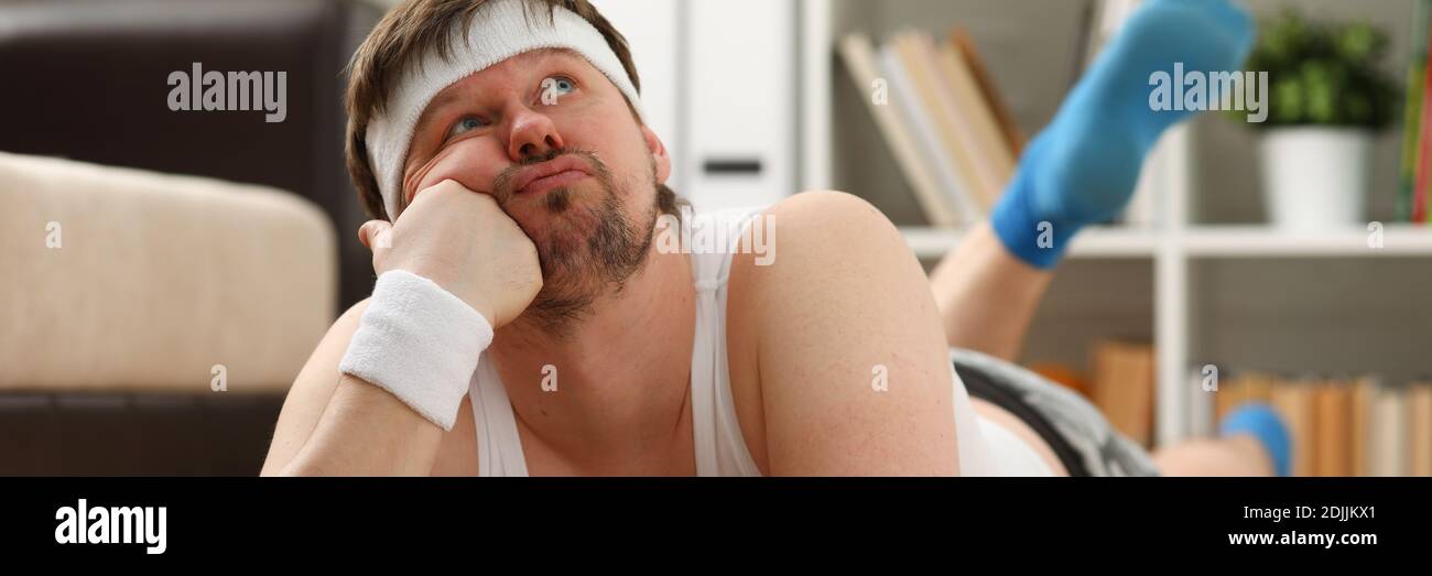 Bored man lying on the floor at home Stock Photo - Alamy