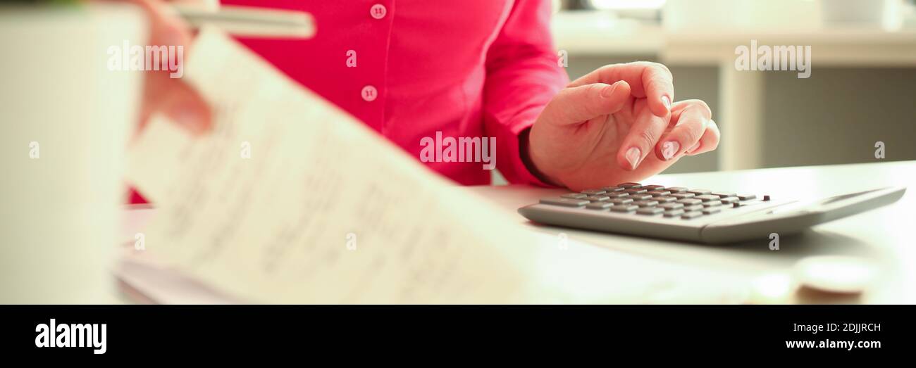 Female office worker using calculator at work Stock Photo - Alamy