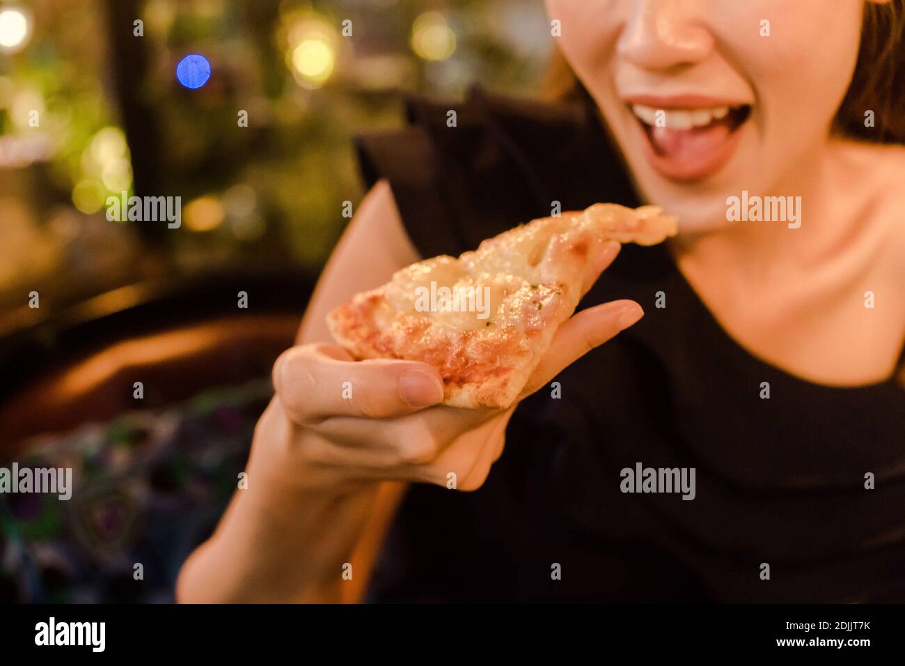 Indian woman eating pizza hi-res stock photography and images - Alamy