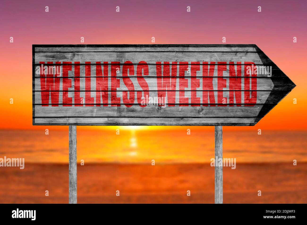 Red Wellness Weekend wooden sign with on a beach background Stock Photo ...