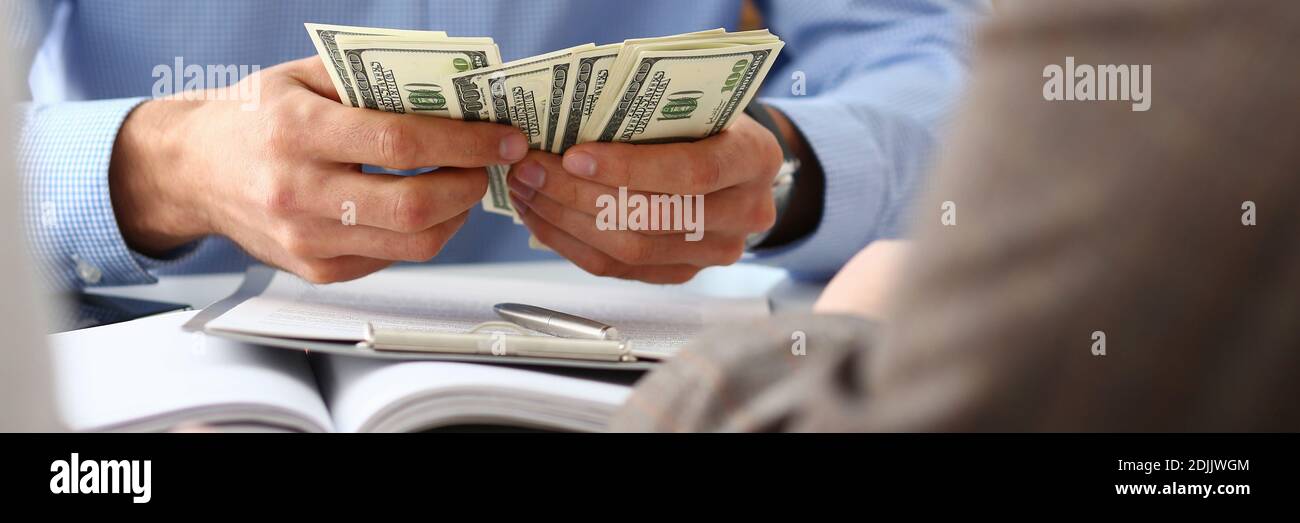 Young man hands counting money in office Stock Photo - Alamy