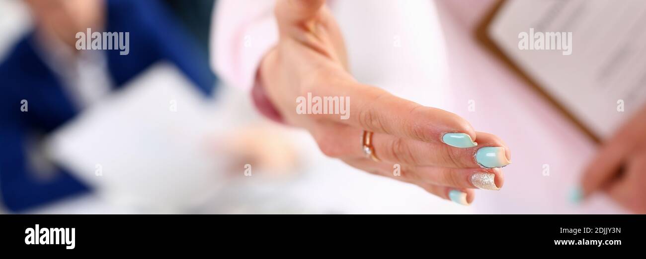 Female office worker extending hand for handshake Stock Photo - Alamy