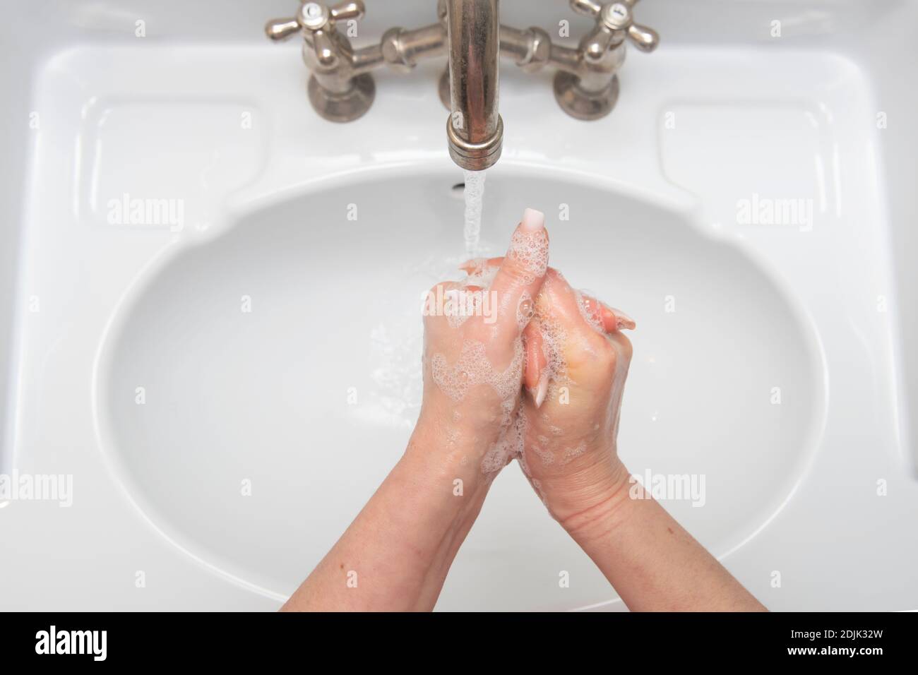 Woman washing hands under running water Stock Photo - Alamy