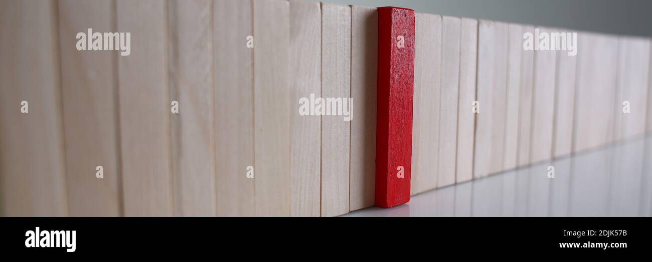 Wooden blocks with red leader forming straight line Stock Photo - Alamy