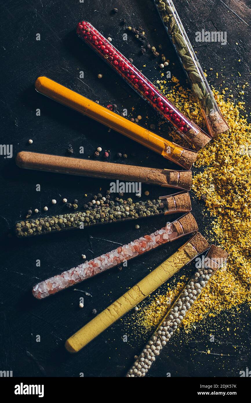 A set of spices in small jars with cork lids. Pink salt, ginger ...