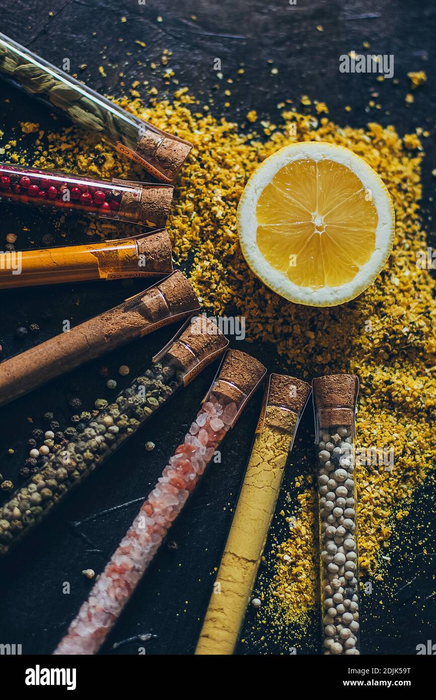 A set of spices in small jars with cork lids. Pink salt, ginger ...