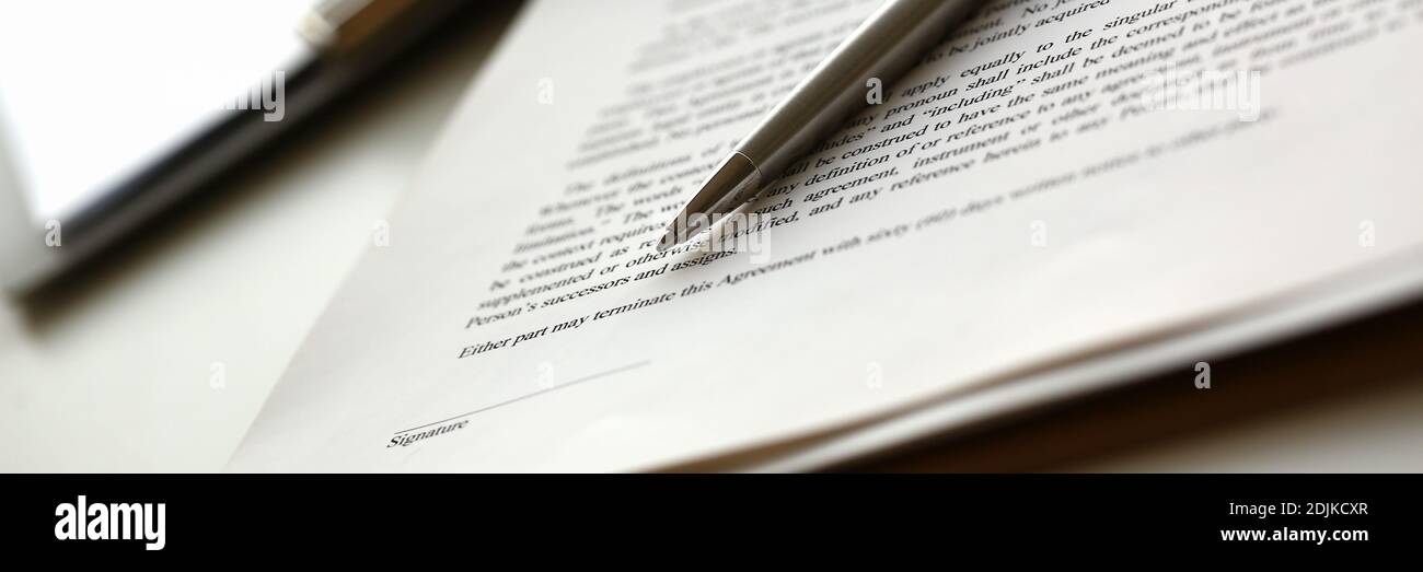 Silver pen and documents on office table Stock Photo - Alamy