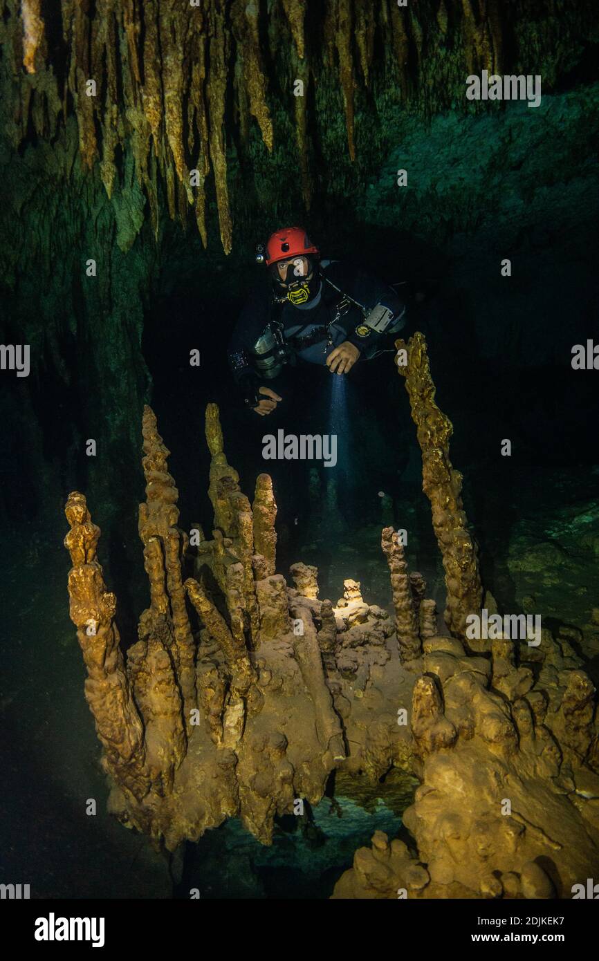 Man Wearing Pollution Mask By Rock Formations In Cave Stock Photo - Alamy