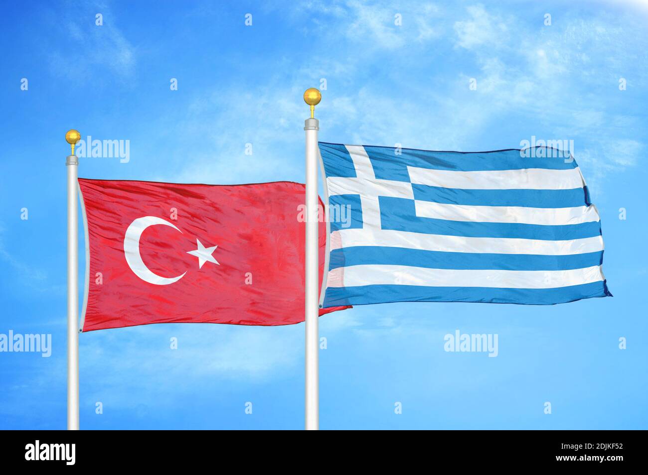 Turkey and Greece two flags on flagpoles and blue cloudy sky Stock ...
