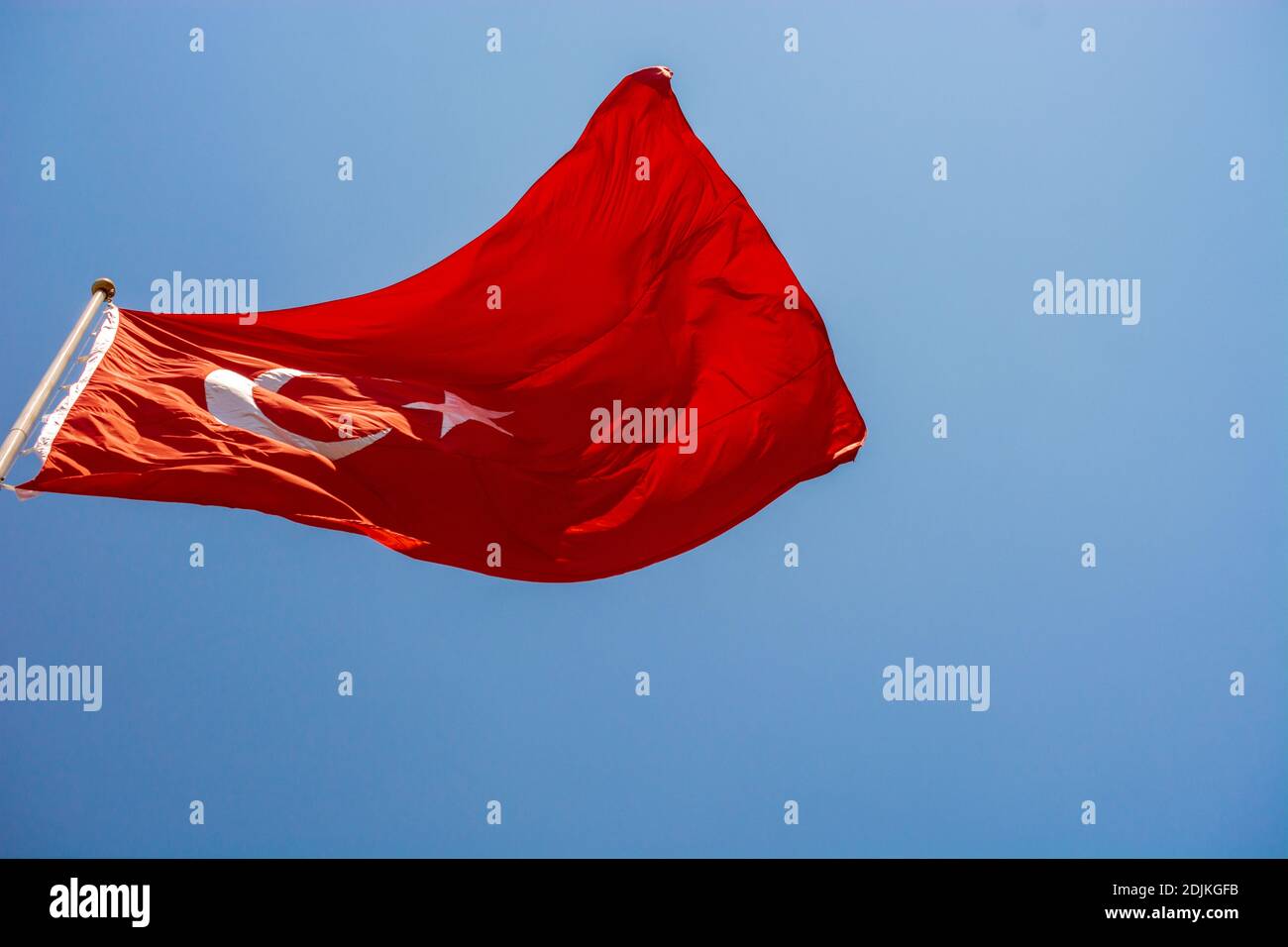 Turkish national flag with white star and moon on a pole in sky Stock ...