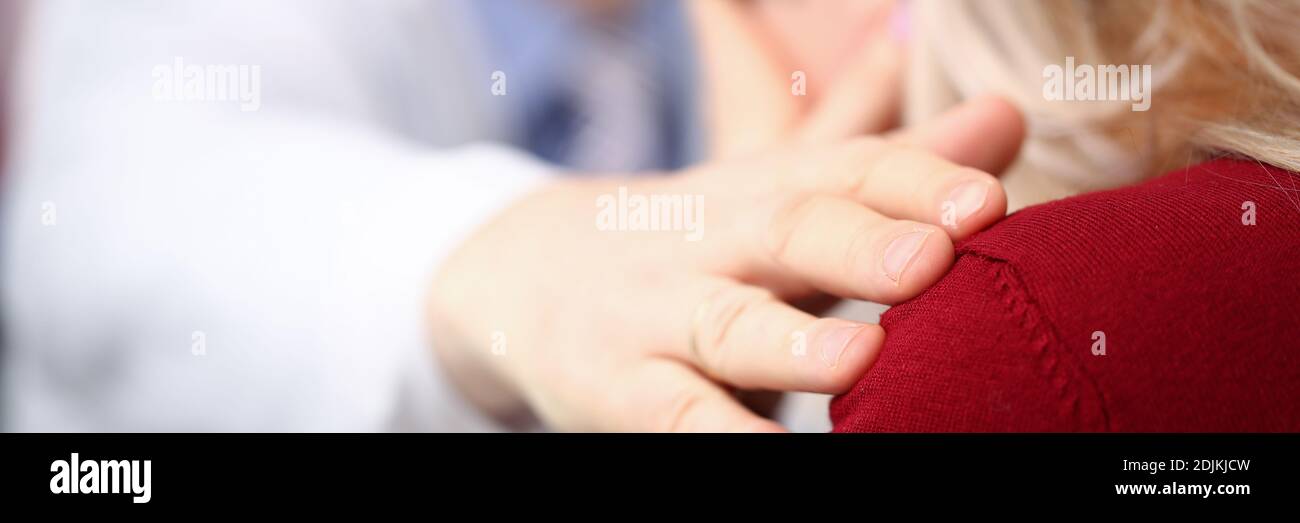 Male doctor comforting crying patient in clinic Stock Photo - Alamy