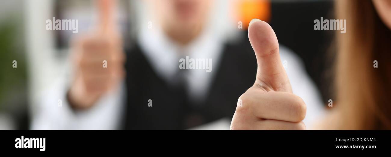 Business colleagues giving thumbs up at work Stock Photo - Alamy