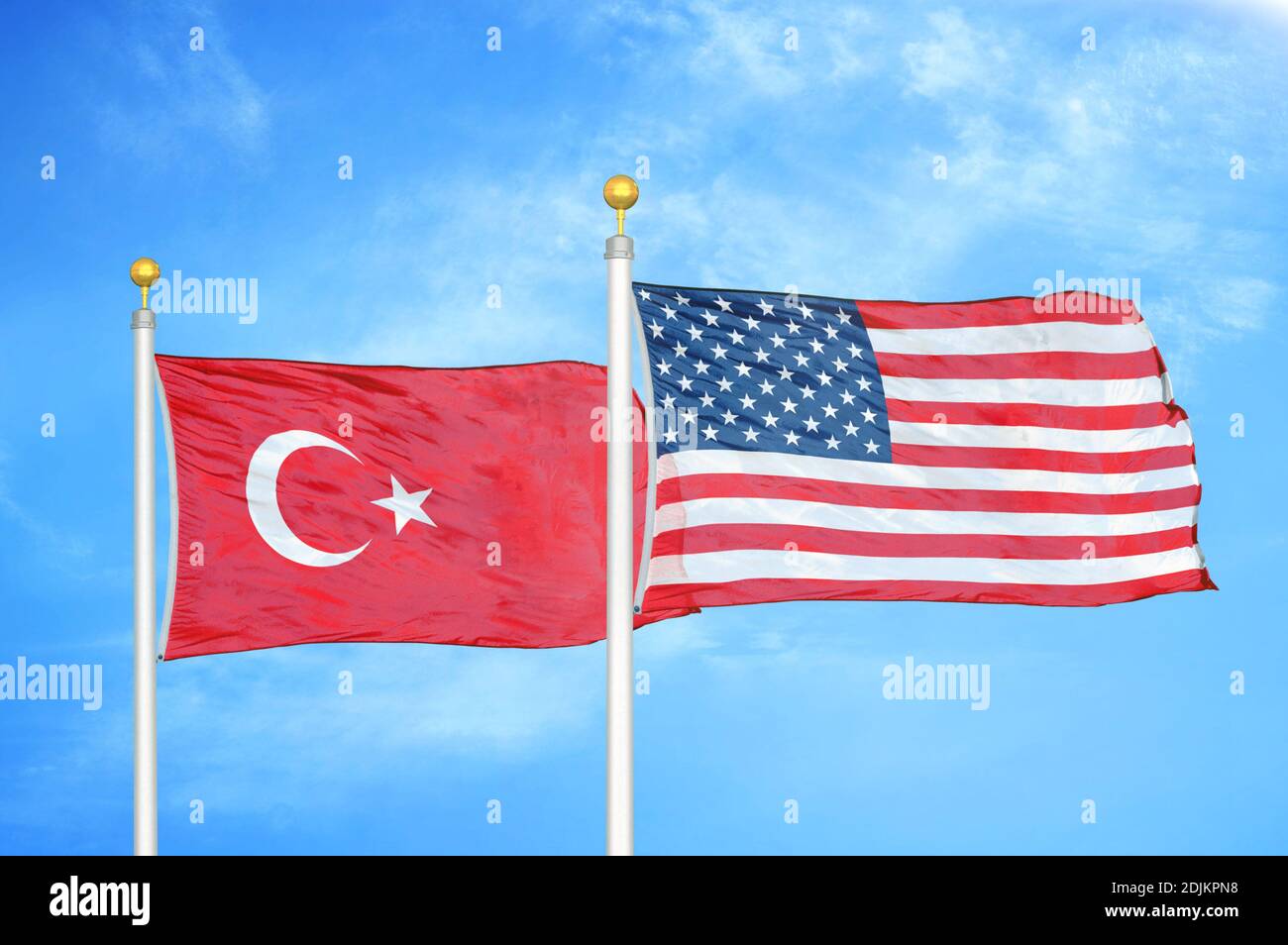 Turkey and United States two flags on flagpoles and blue cloudy sky ...
