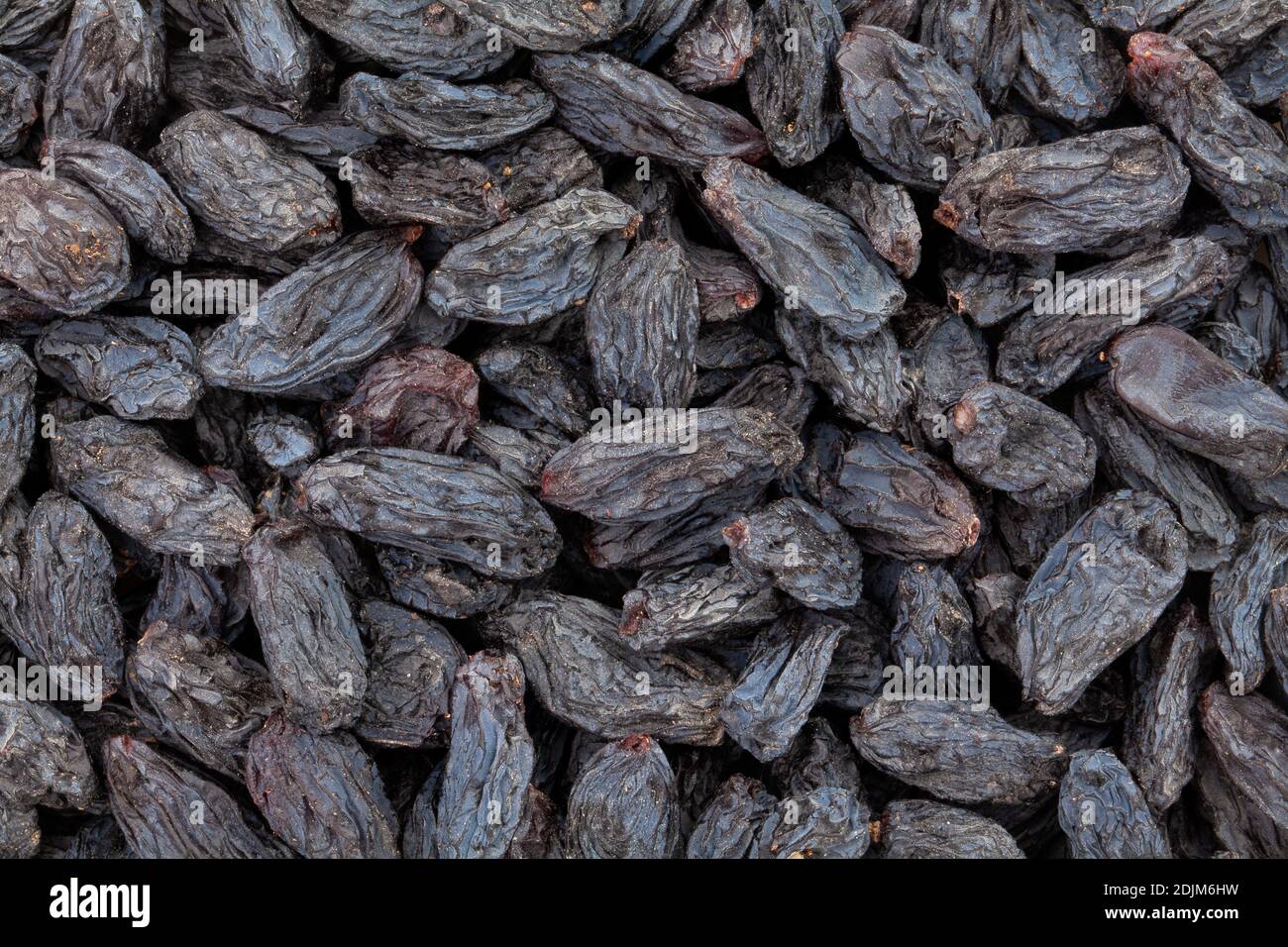 black raisins closeup texture background Stock Photo - Alamy