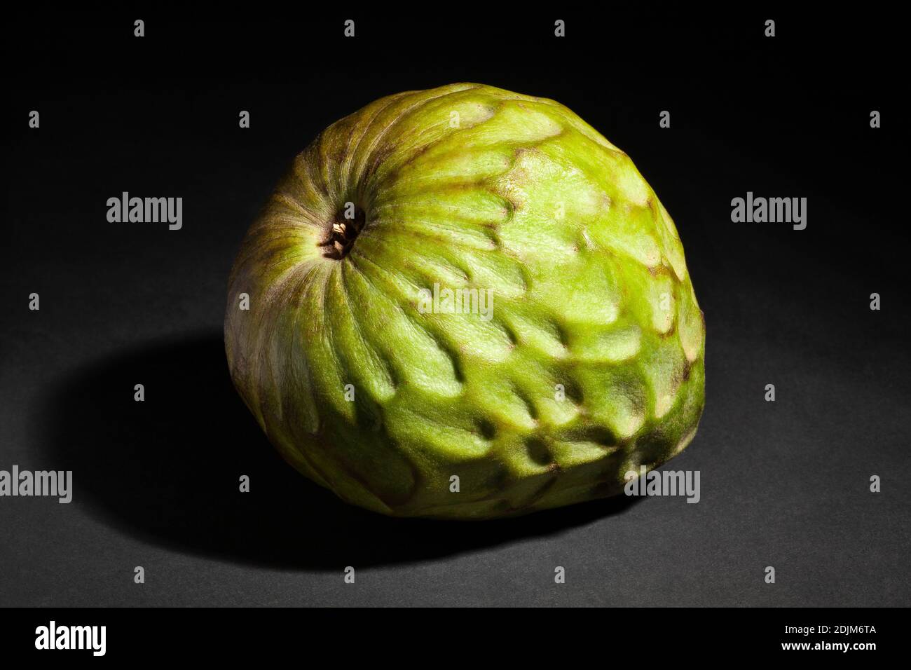 one cherimoya on black background Stock Photo - Alamy