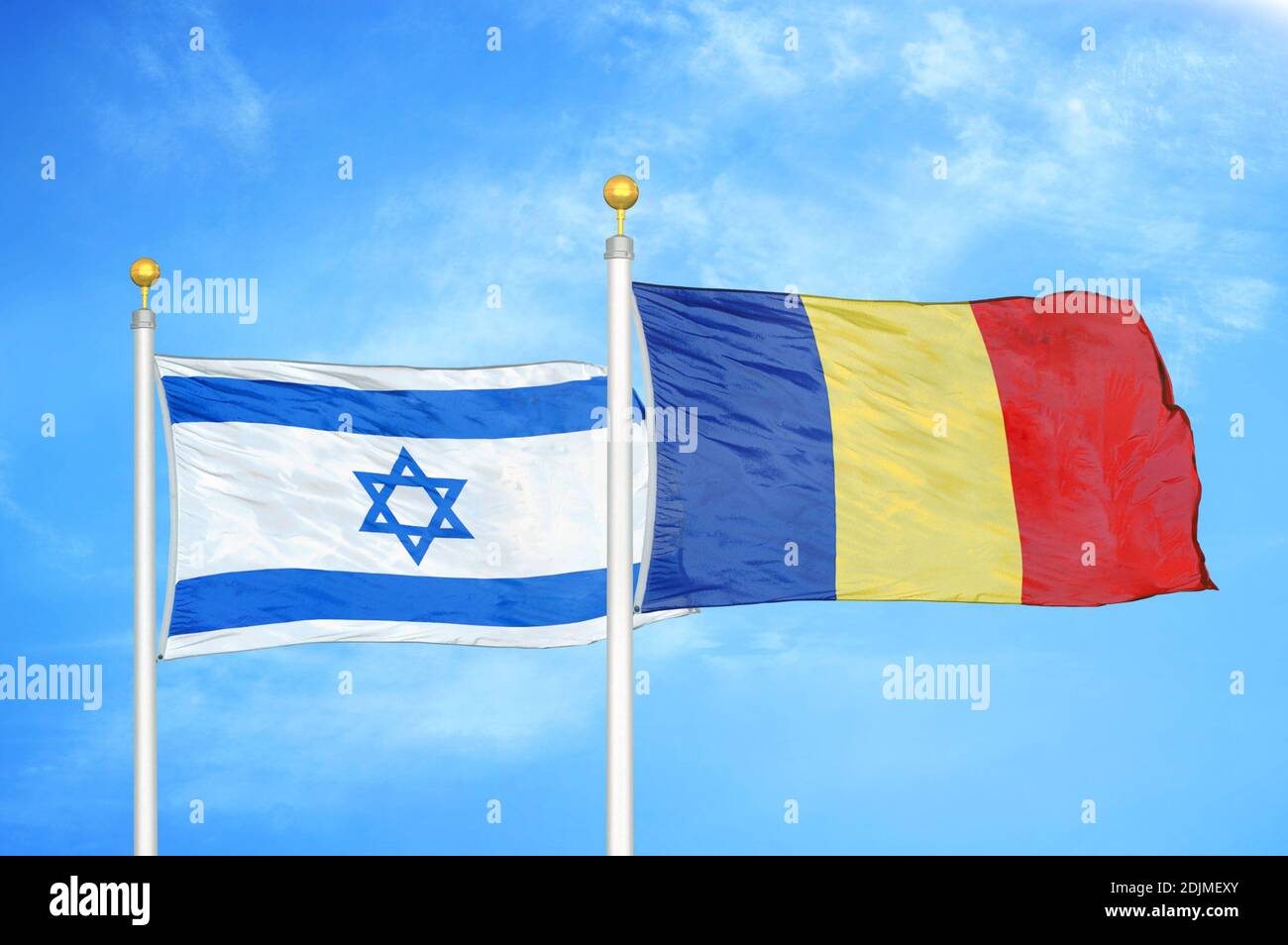 Israel and Romania two flags on flagpoles and blue cloudy sky Stock ...