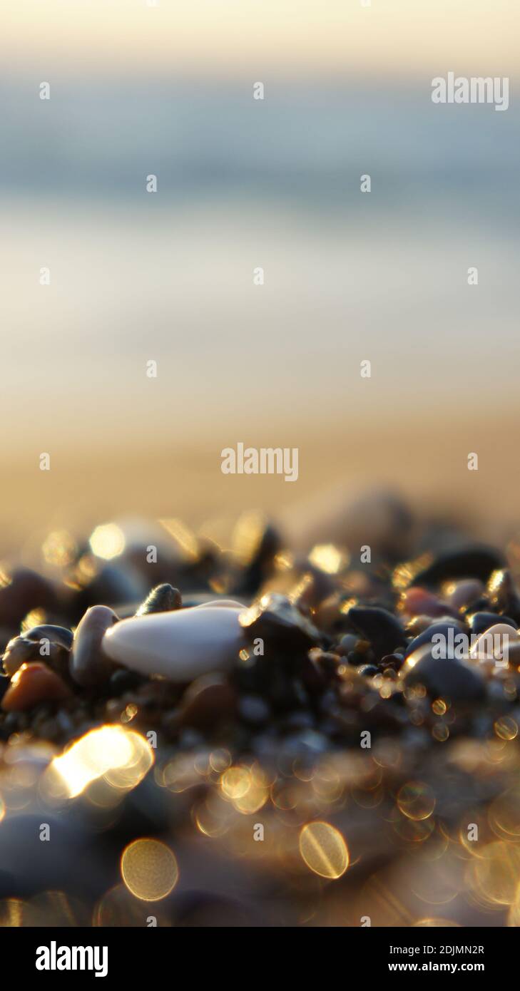 Athens, Greece November 28th reflections of sunset light on the beach ...