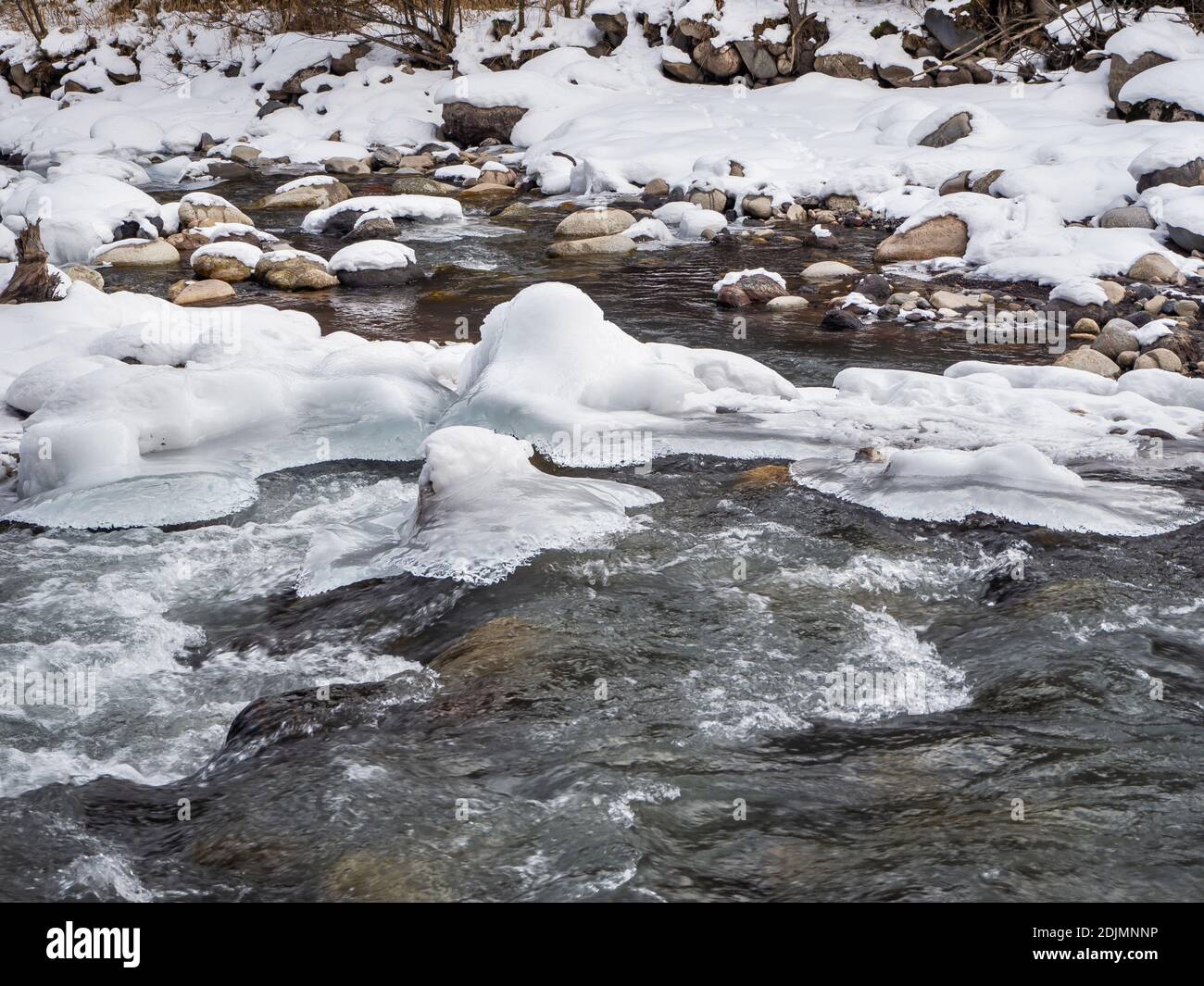 Aerial view of the winter mountain river in the Cheget valley Stock ...
