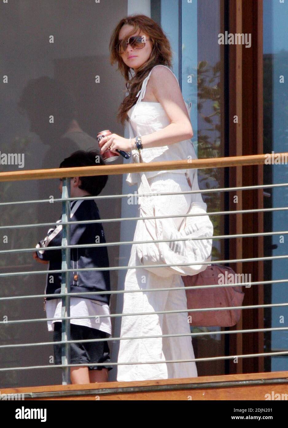 Lindsay Lohan jumps back in time wearing a satin 1980's style jumpsuit ...