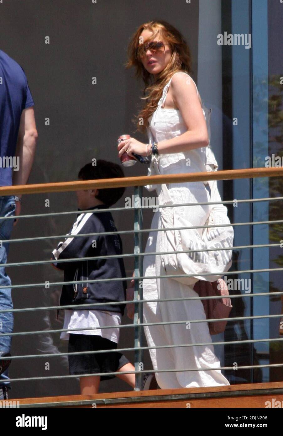 Lindsay Lohan jumps back in time wearing a satin 1980's style jumpsuit ...