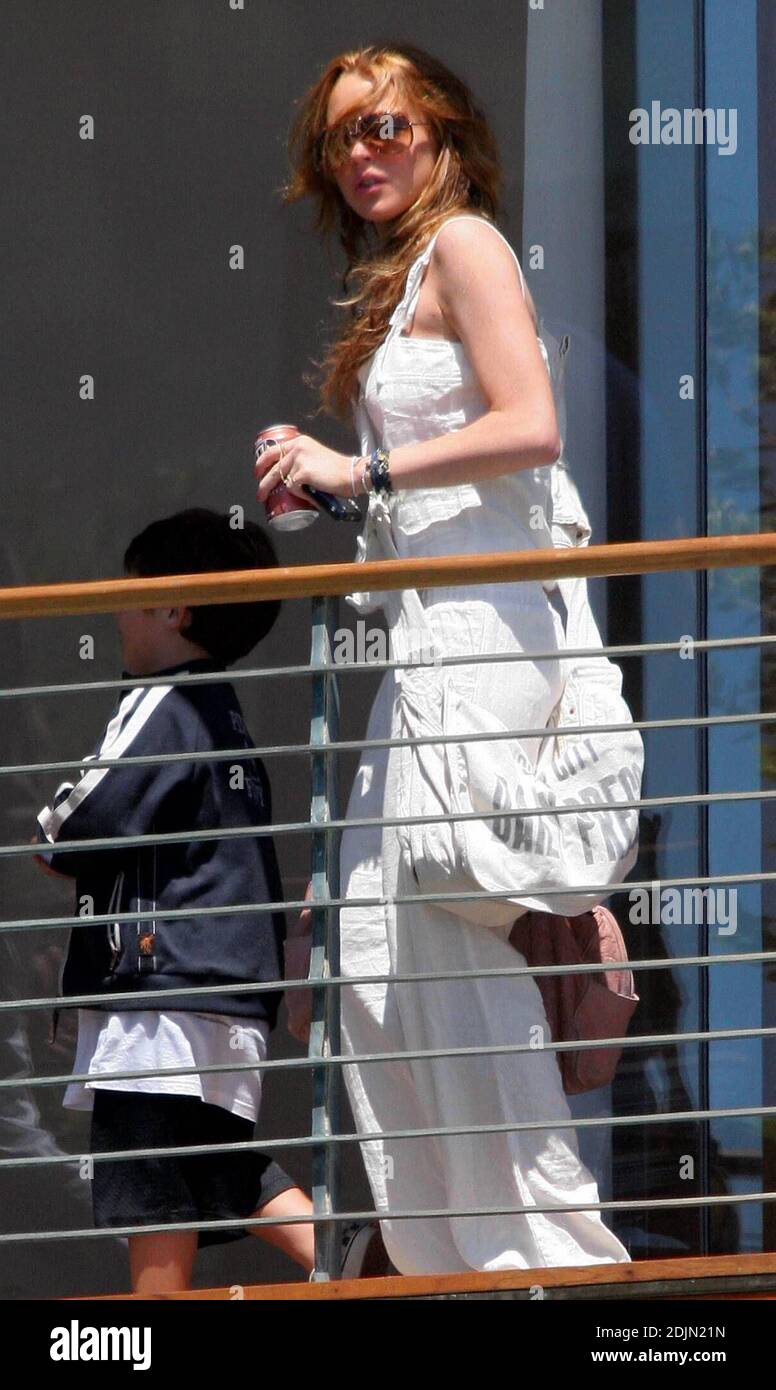 Lindsay Lohan jumps back in time wearing a satin 1980's style jumpsuit ...