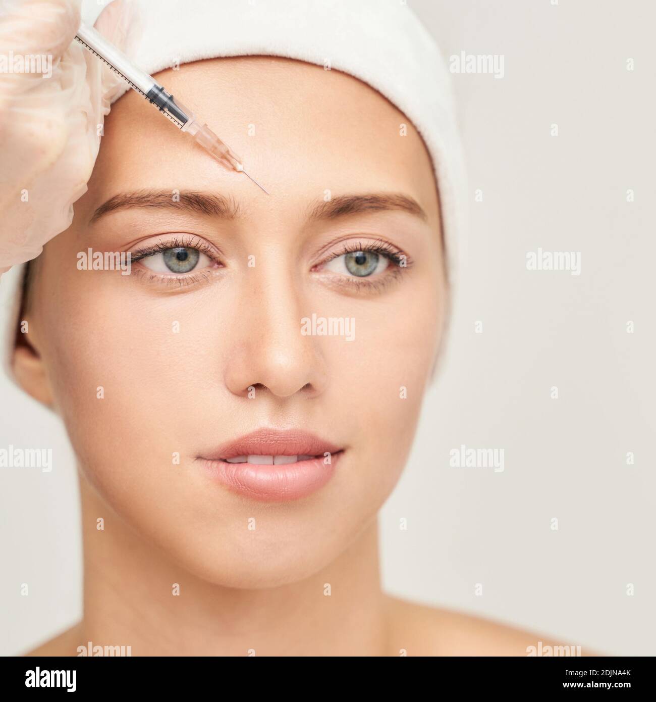 Forehead injection at spa salon. Doctor hands. Pretty female patient ...