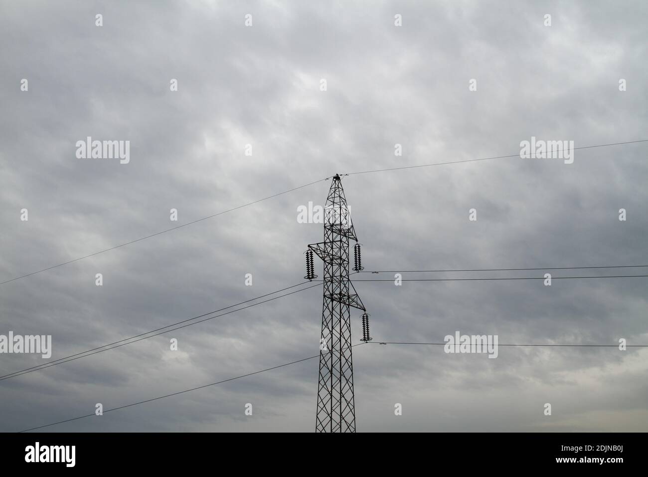 Power line against a dramatic cloudy sky Stock Photo - Alamy