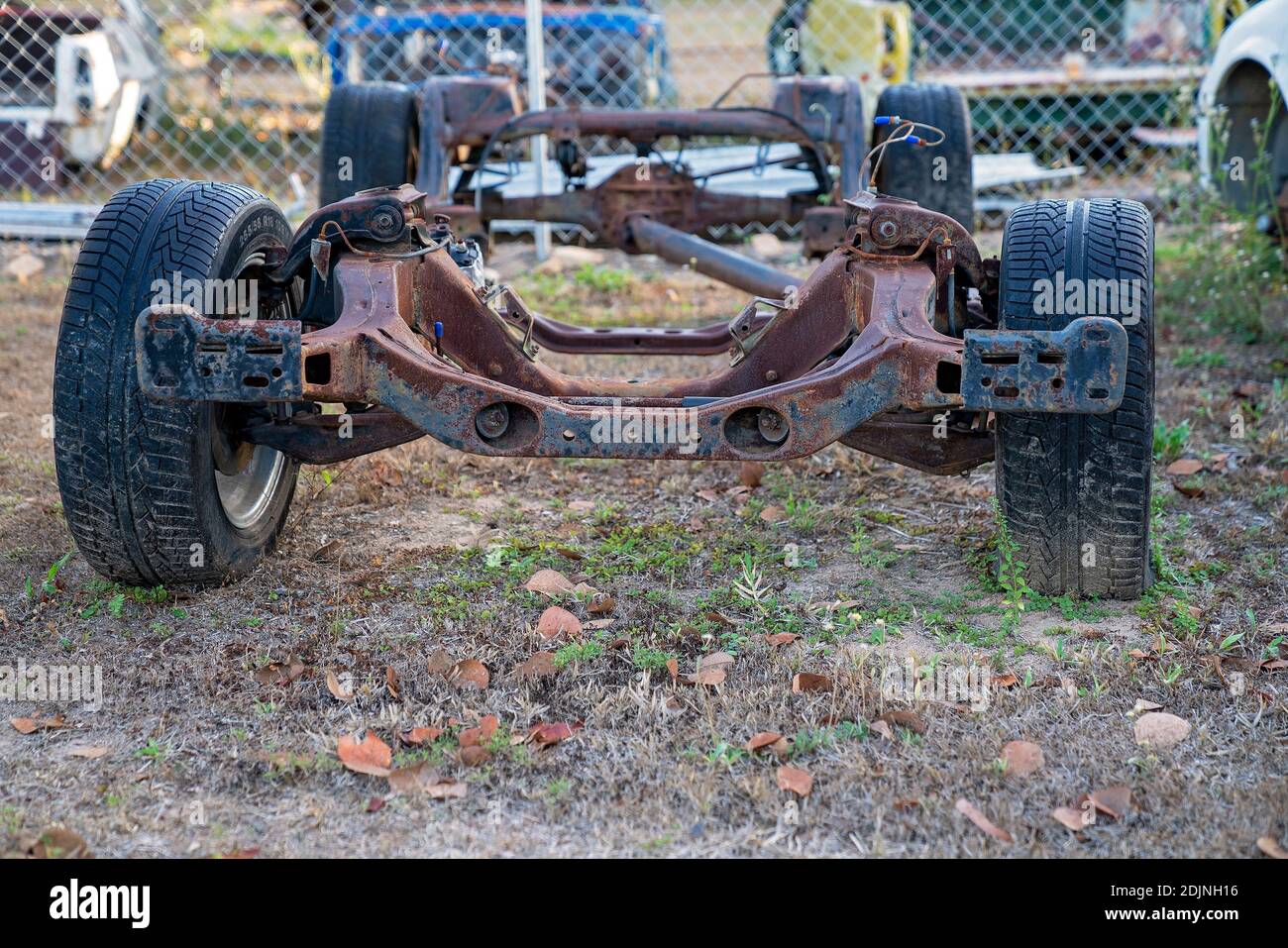 An old car chassis discarded in a rural backyard Stock Photo - Alamy