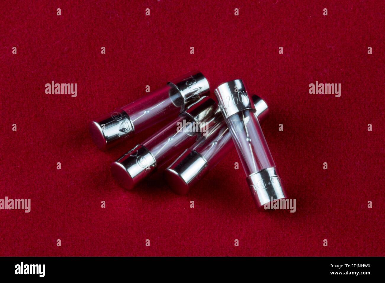 Small electrical fuses piled on a red table top Stock Photo - Alamy