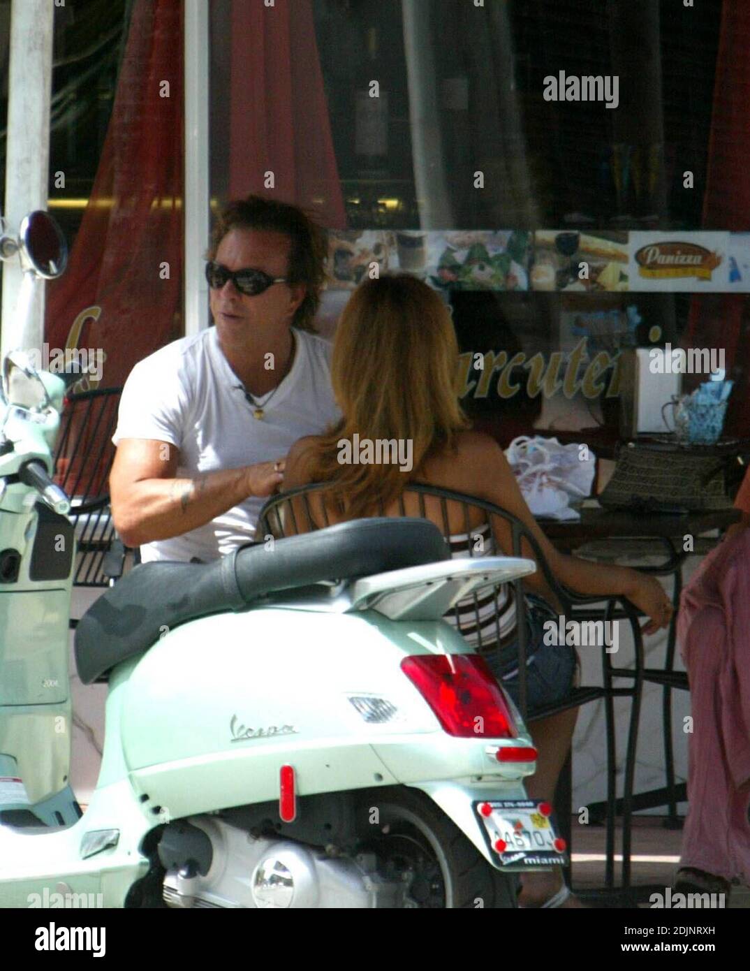 Mickey Rourke drinks coffee and plays with his dog in the company of ...