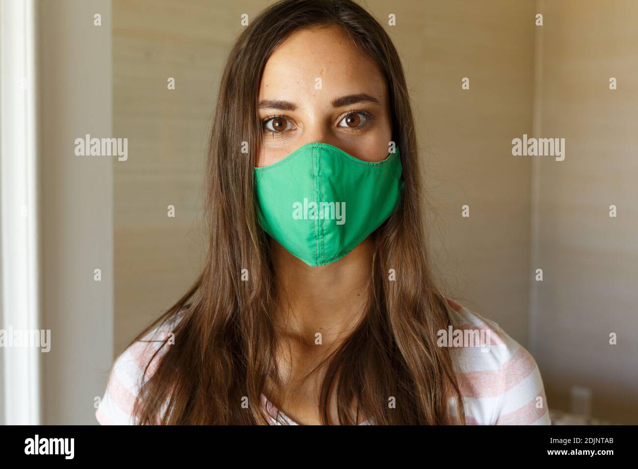 Woman wearing green face mask hi-res stock photography and images - Alamy