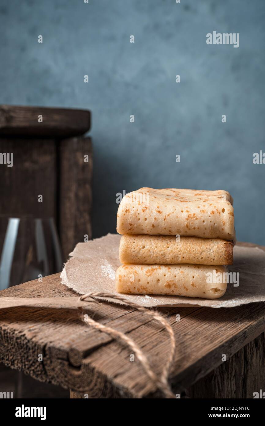 Three folded pancakes on a paper plate. Side view, with space for ...