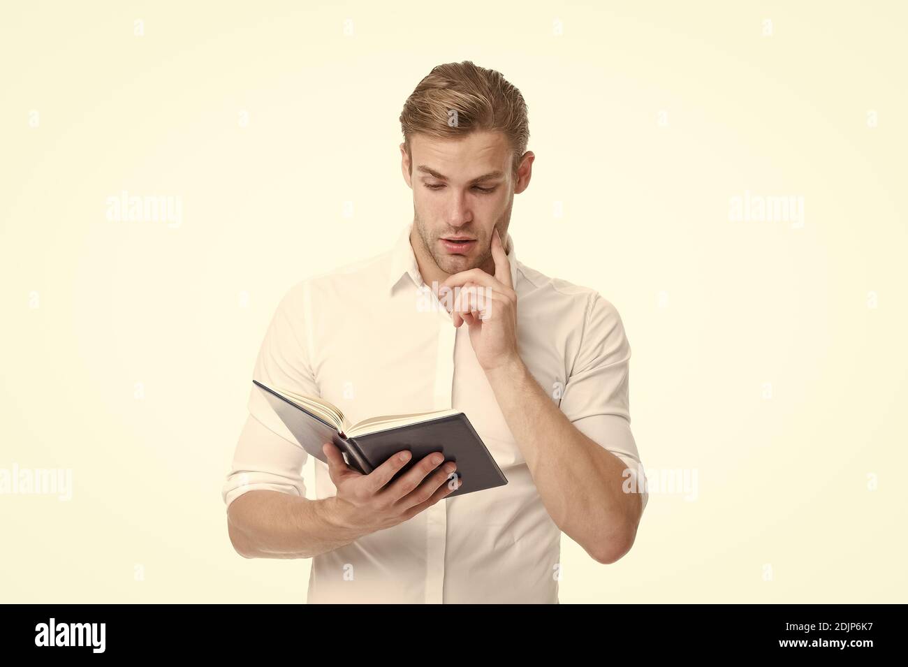 Reading feeds imagination. Young student read book isolated on white ...