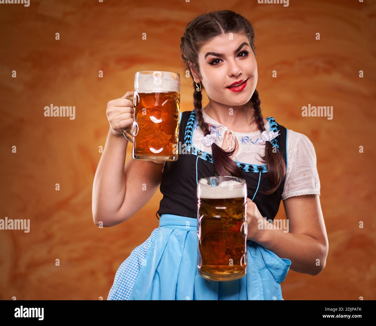 German girl in traditional costume with two large pints of lager Stock ...