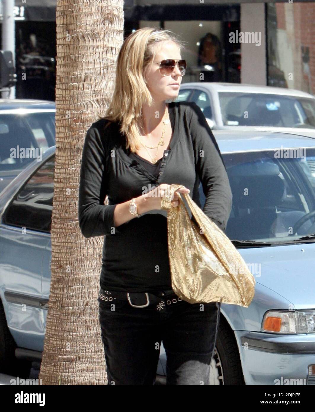 A pregnant Heidi Klum flaunts her bump in a tight fitting top and wears ...