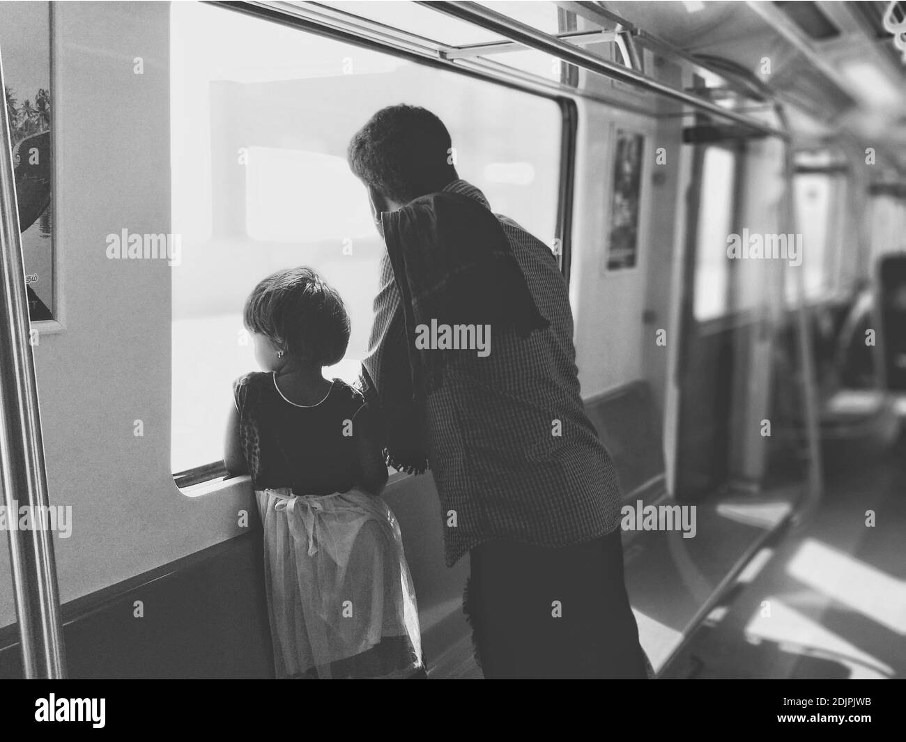 Man looking through train window Black and White Stock Photos & Images ...