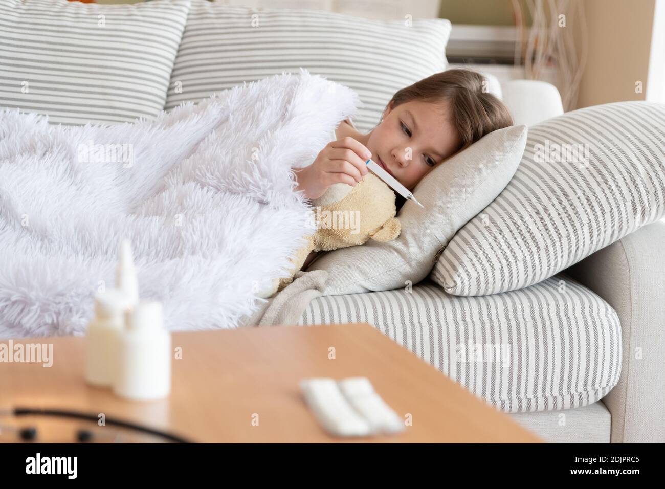Sick girl lying bed thermometer virus hi-res stock photography and ...