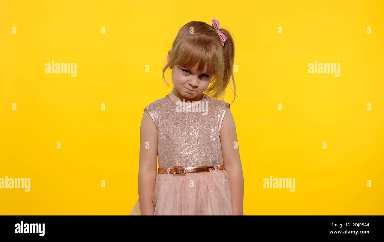 Little kid feels guilty. Shy shamed child girl, 5-6 years old in dress ...