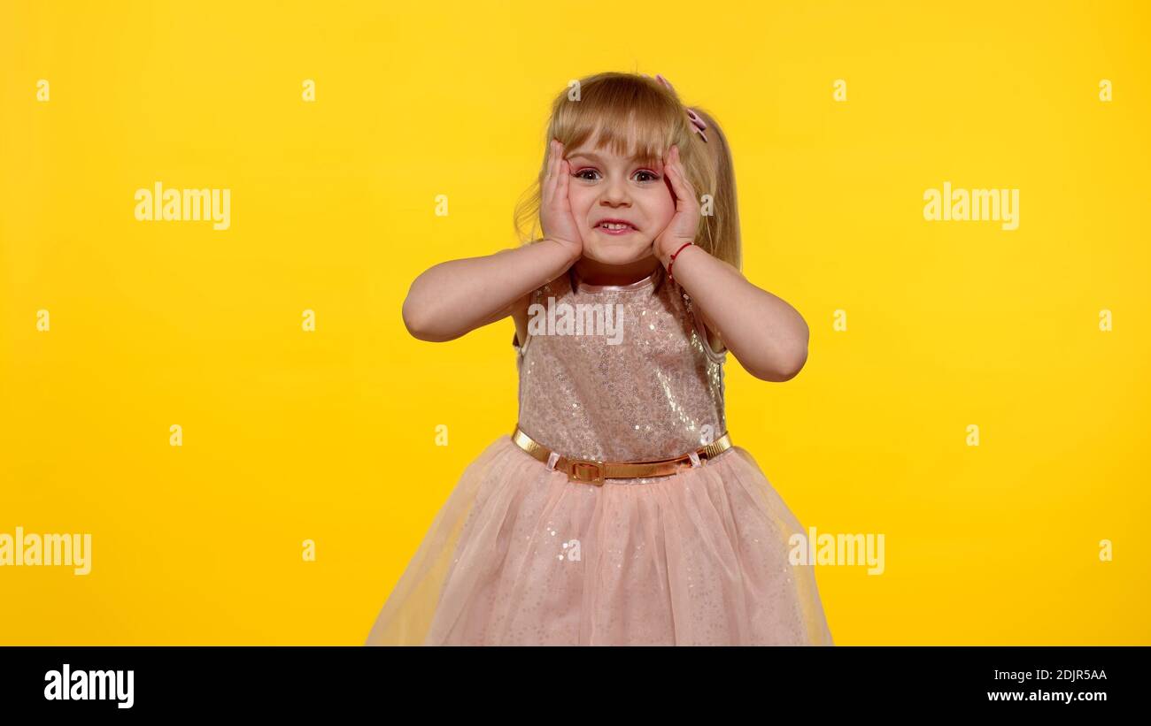 Portrait of happy amazed astonished young kid girl in shiny dress ...