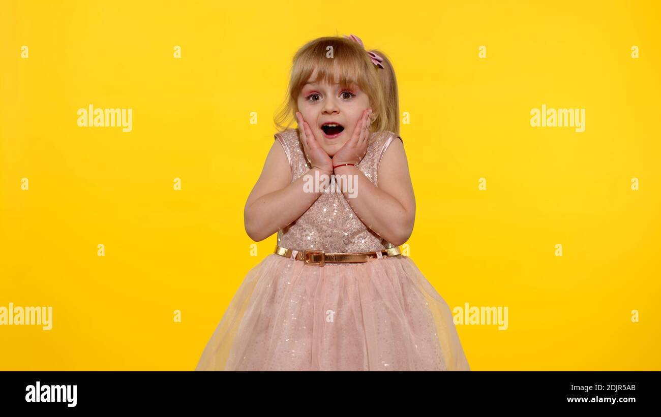 Portrait of happy amazed astonished young kid girl in shiny dress ...