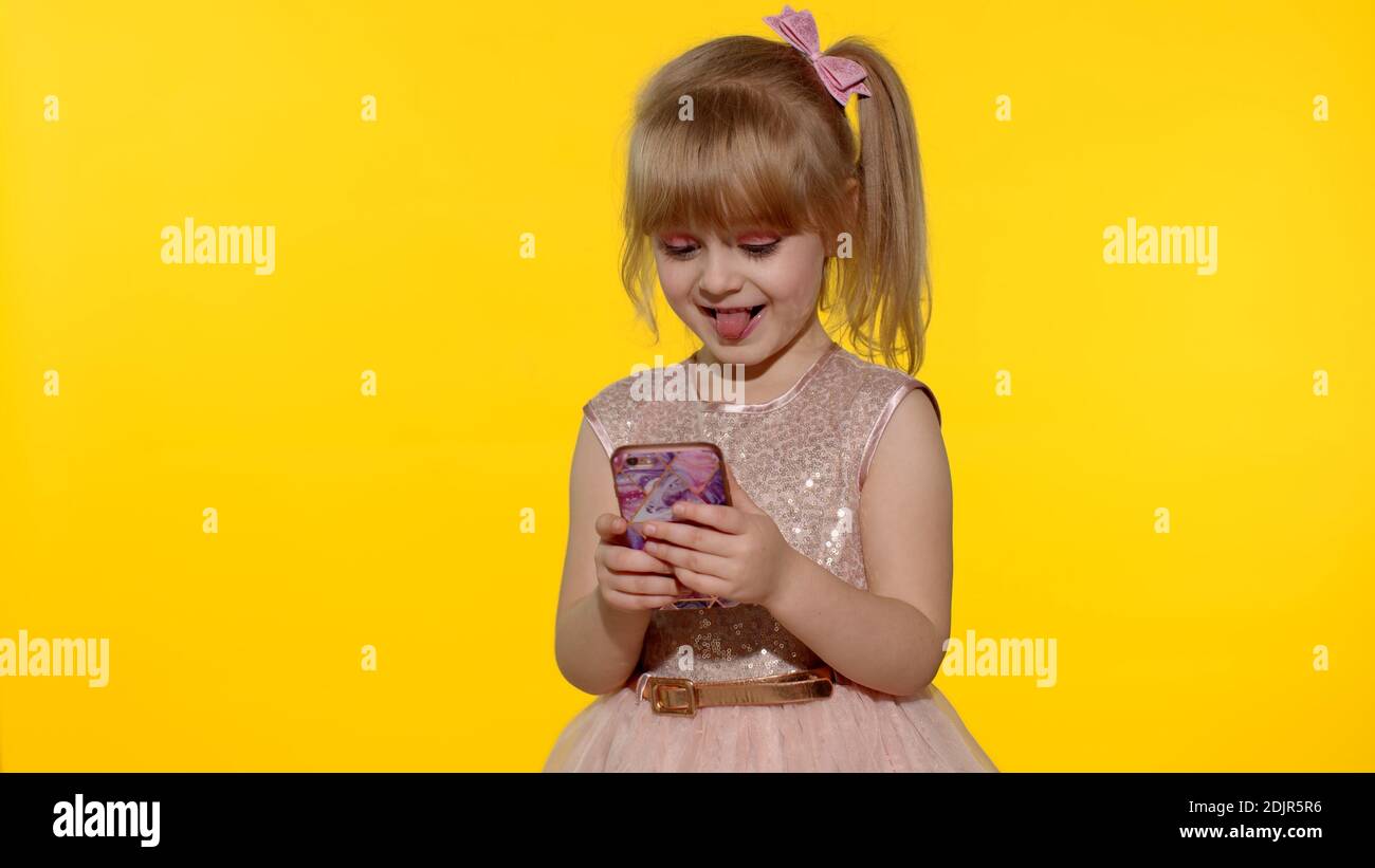 Little girl using smartphone. Portrait of child texting on smartphone ...