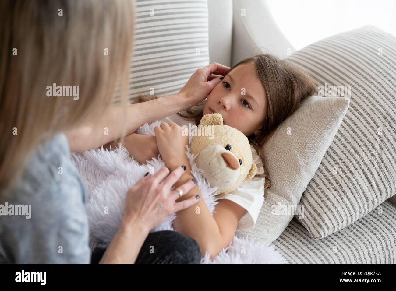 A tender mother looks after her sick daughter Stock Photo - Alamy