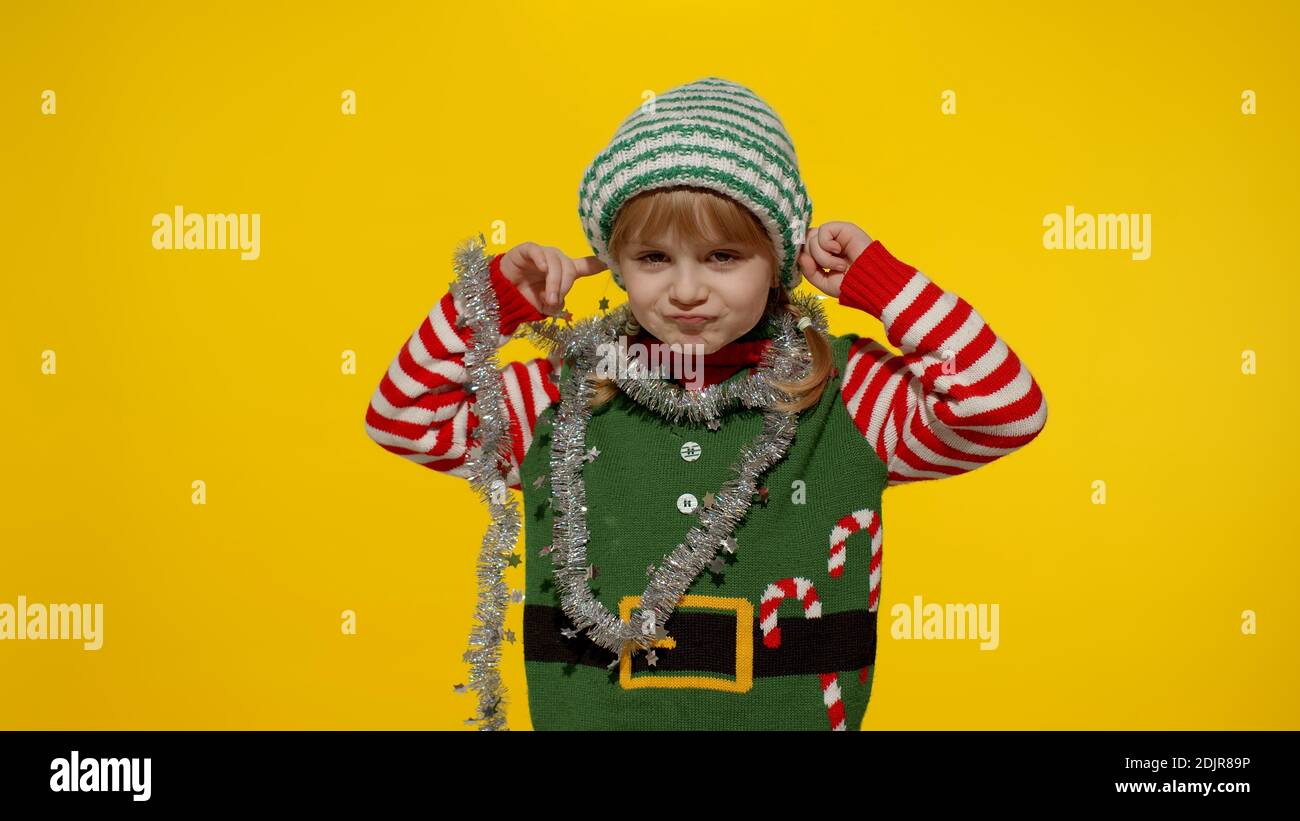 Displeased little blonde kid teen teenager girl in Christmas elf Santa ...
