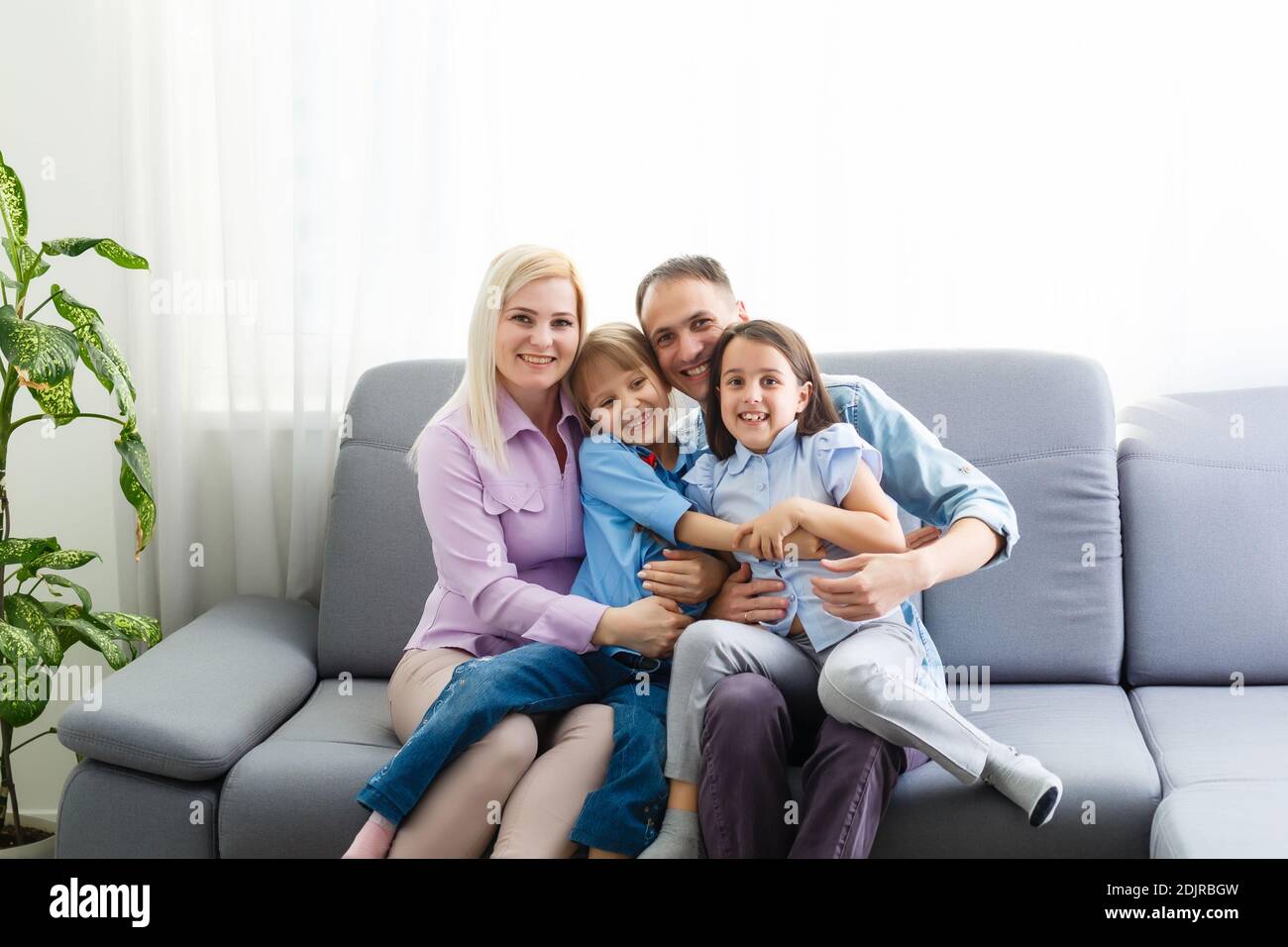 Portrait of a happy family smiling at home Stock Photo - Alamy