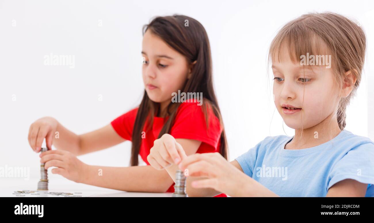 Two kids counting coins together Stock Photo - Alamy