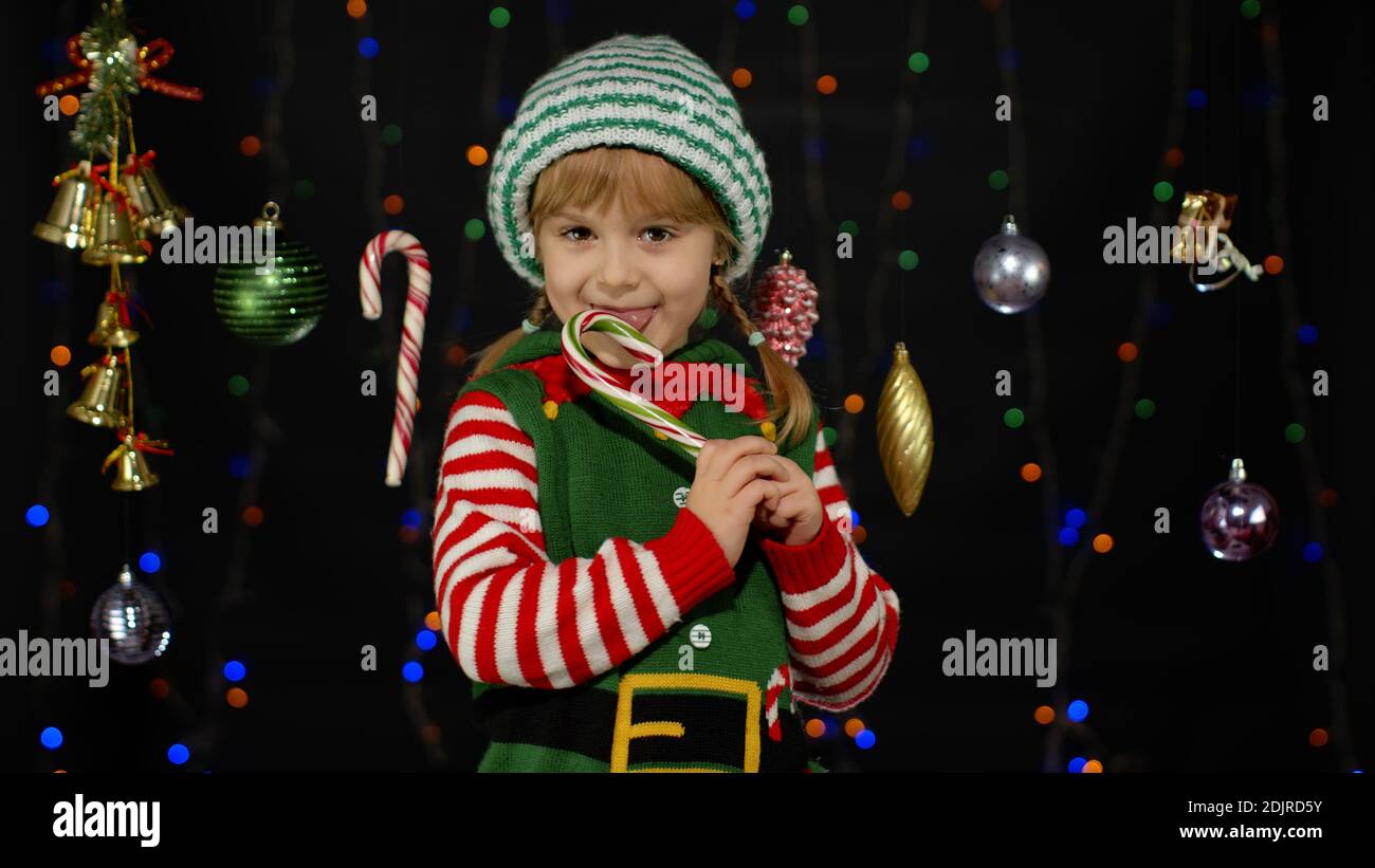 People New Year holidays celebration. Blonde kid girl in Christmas elf ...