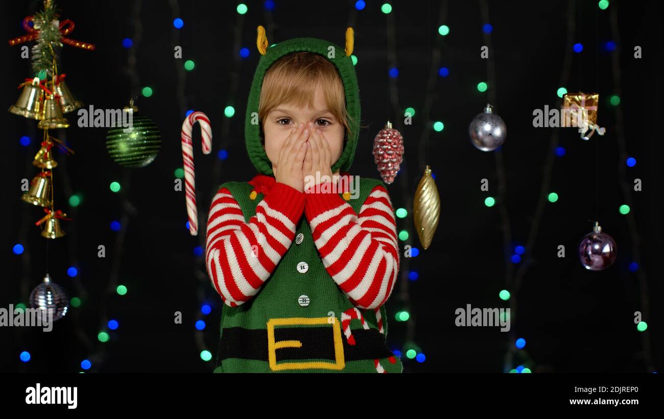 Impressed child kid girl in Christmas elf Santa Claus helper costume ...